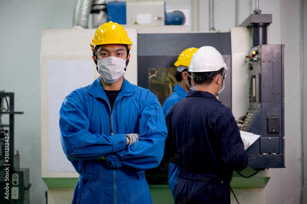 Factory worker man with mask and safety uniform stand with confidence ...