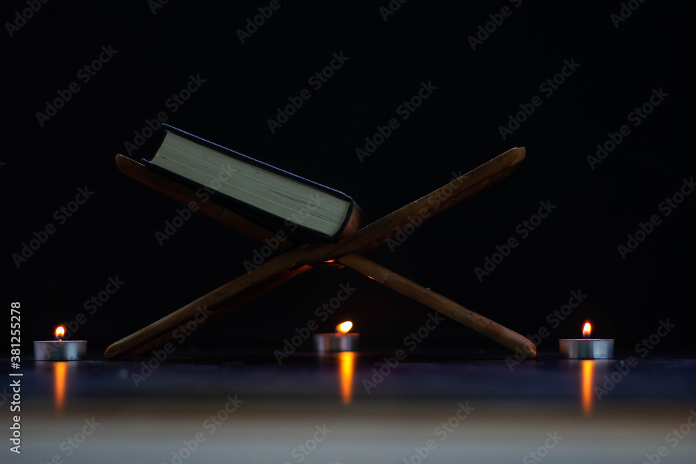 Quran in the mosque - open for prayers The black background of the ...