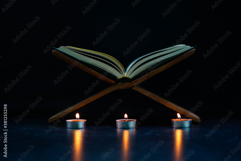 Quran in the mosque - open for prayers The black background of the ...