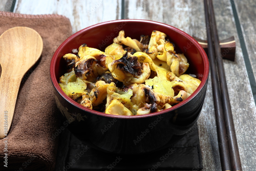 Bowl of cutting grilled marinated octopus topping on cooked rice ...