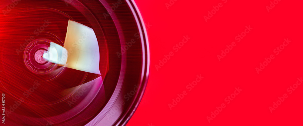Banner. The camera lens and the beautiful light red color. The red rays ...