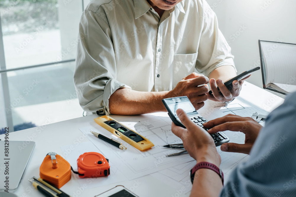 Male architect in the office talks about the construction project. Team ...