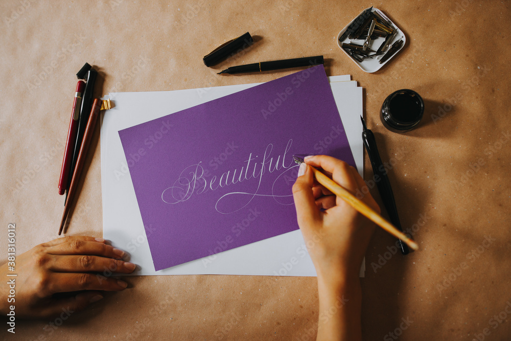 Beautiful, calligraphy. Top view of a word beautiful written with ...