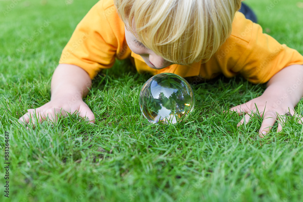 Child learning about nature outside through play and exploring the ...