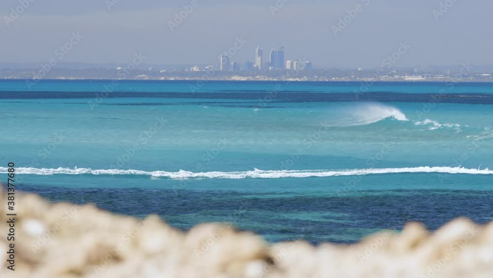 Leisure boat and Waves on Rottnest Island with Perth city in the ...