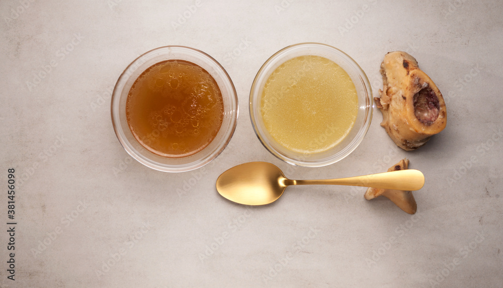 Two types of bone broth in glass bowls. Top view, copy space. Beef ...