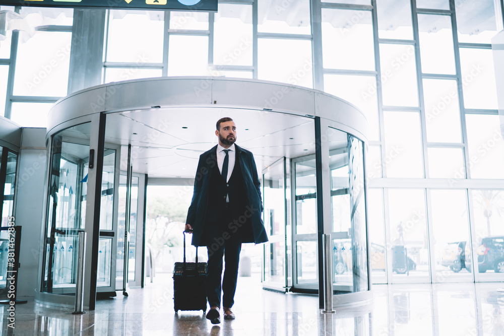 Pensive manager with suitcase luggage thoughtful looking away while ...