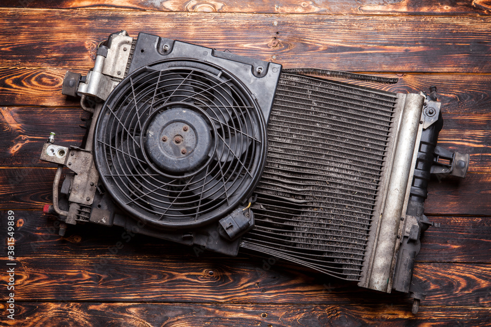 Old and leaky car radiator taken out of the car and lying on the old ...