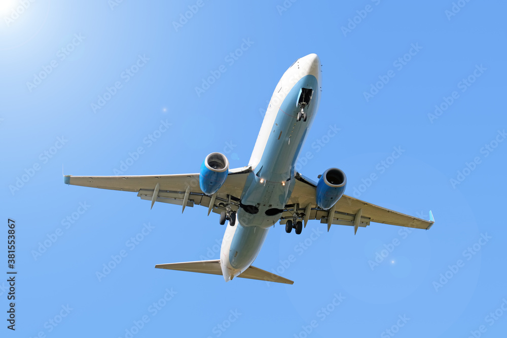modern airplane flying high against blue sky background. Passenger ...