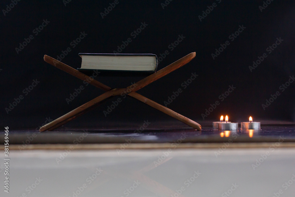 Quran in the mosque - open for prayers The black background of the ...