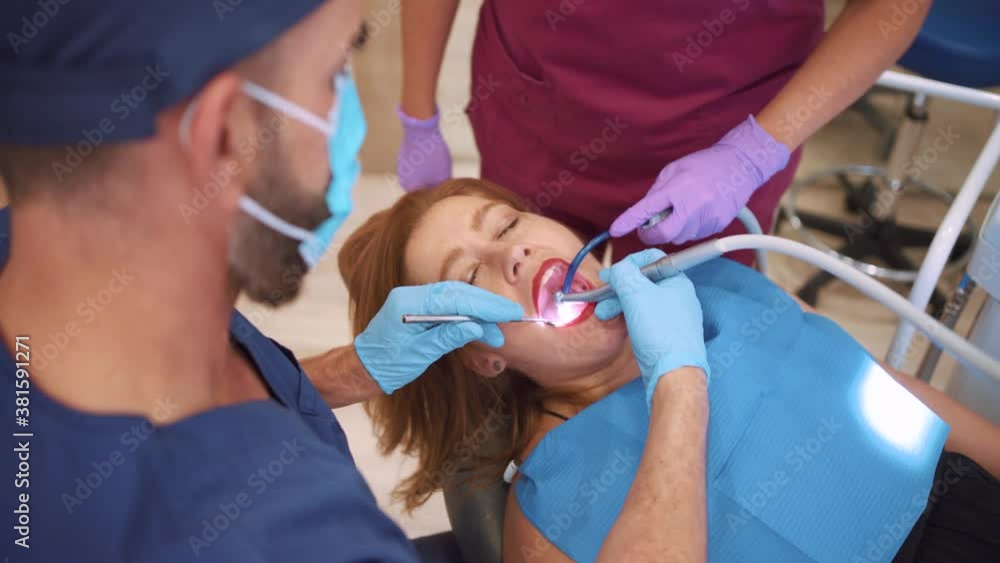 Stock video of woman with her mouth open during dentist revision. Stock ...