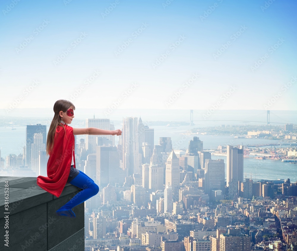 Young girl in superhero costume overlooking the city Stock Photo ...