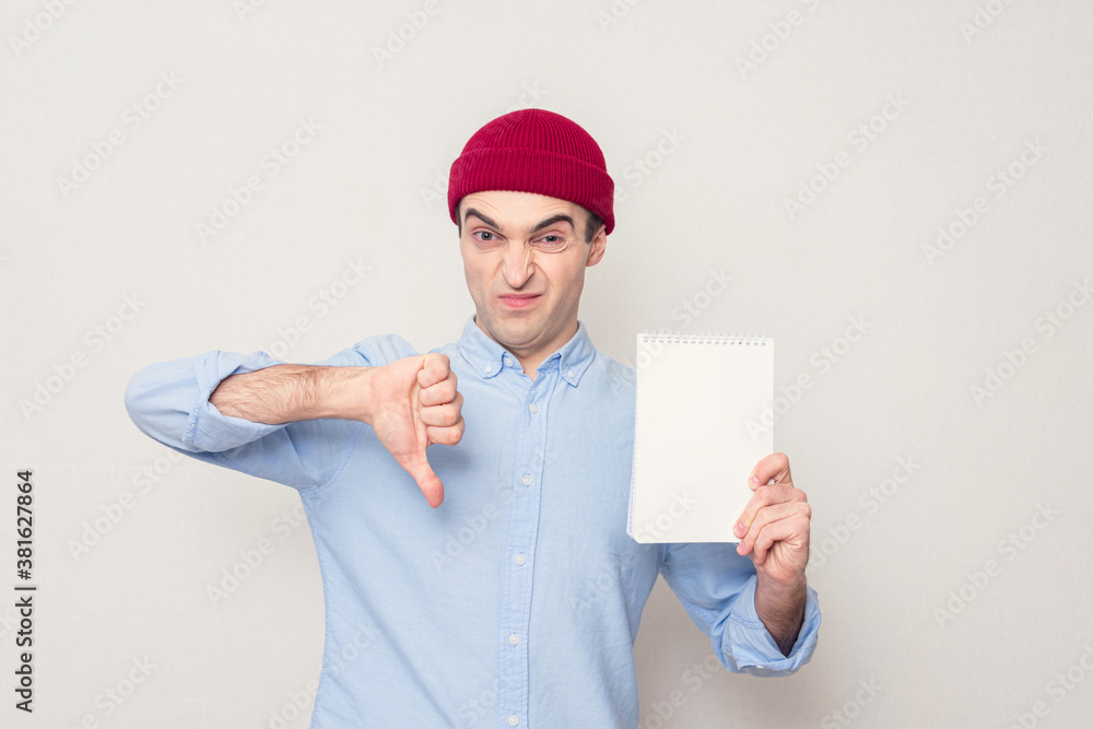 Student with Notepad shows the symbol of the fiasco, white background ...