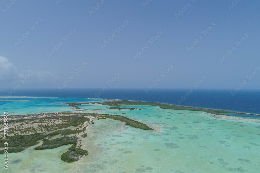 Top view Caribbean Island with mangrove and various shades of blue. Bay ...