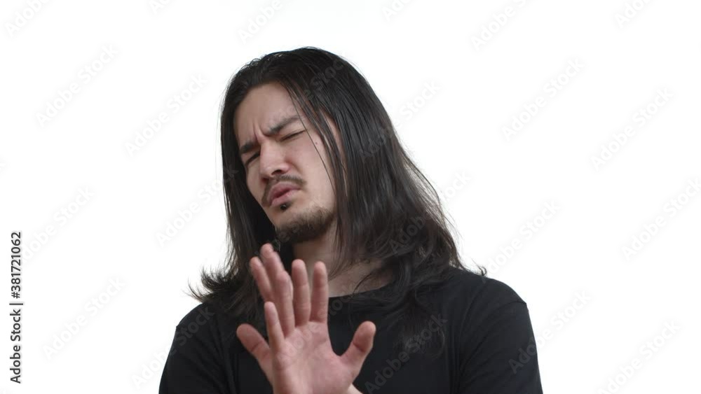 Close-up of unamused handsome asian guy with moustache and long dark ...