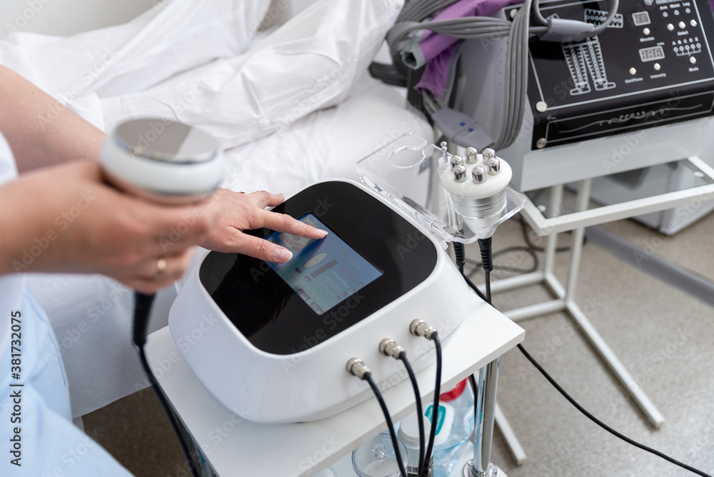 Perfect body radio treatment. Woman at spa procedure. Doctor hand and ...