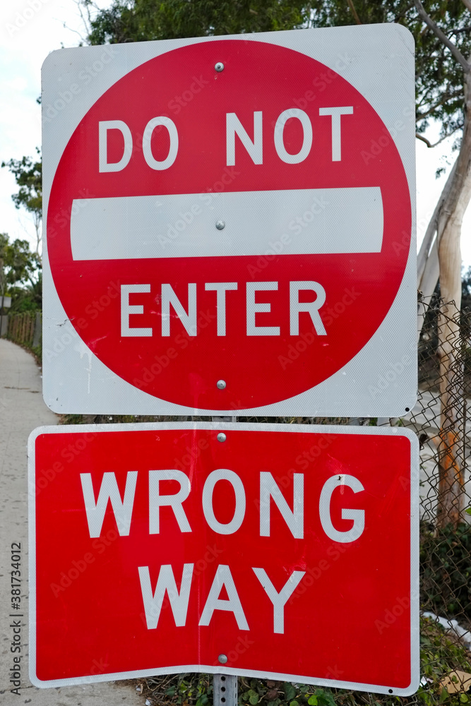 Do Not Enter Wrong Way street sign alert. Road warning post on red ...