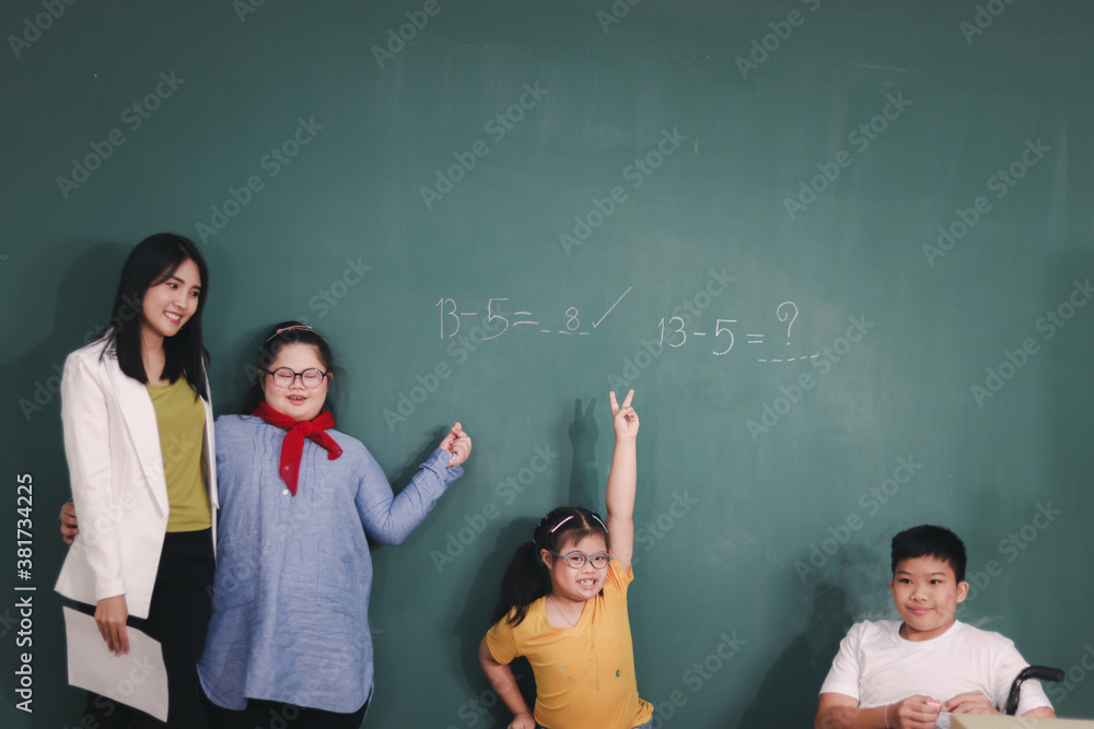 Disabled kids classroom, school boy on wheelchair and down syndrome ...