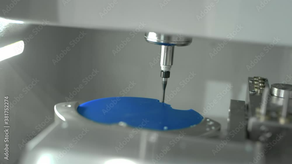 rofessional CNC dental milling machine carving out shape of artificial ...