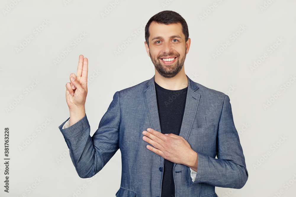 Young businessman man with a beard in a jacket, smiling, swears ...