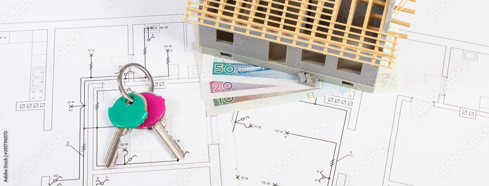 House under construction, polish currency money and keys on electrical ...