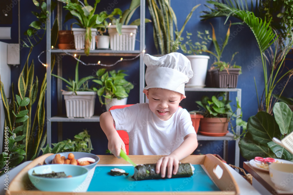 Cute happy smiling Asian little boy child wearing chef hat having fun ...