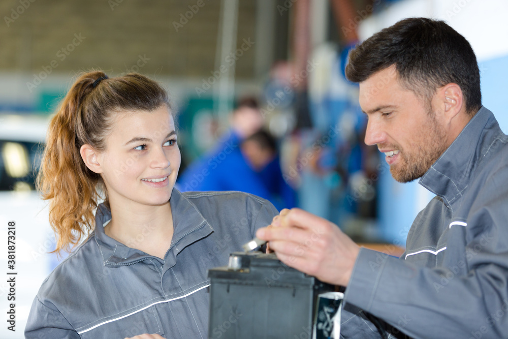 portrait of people replacing car battery Stock Photo | Adobe Stock