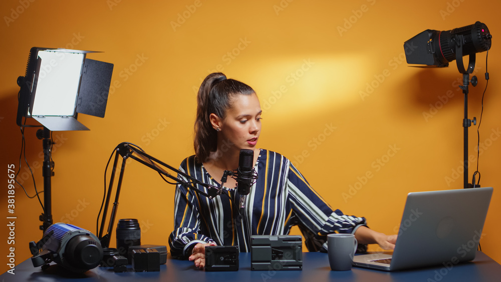 Content creator talking to the camera about two types of v mount batteries. Professional ...