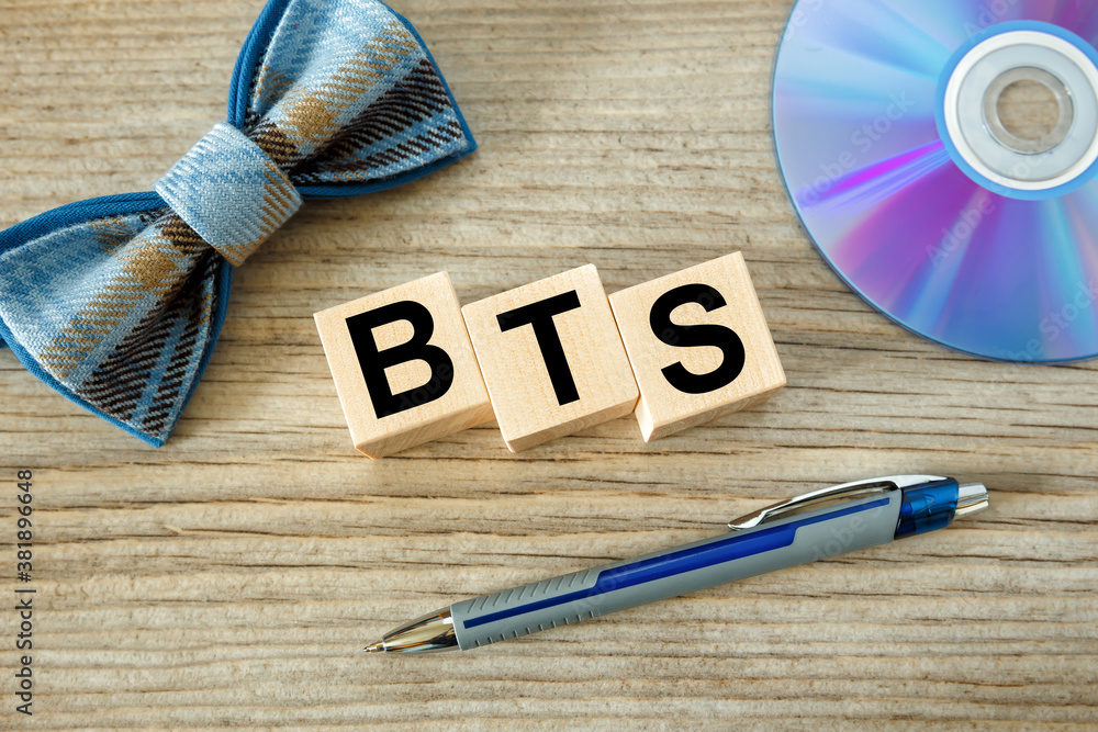 BTS word on CD background, bow tie and pen. South Korean boy band BTS ...