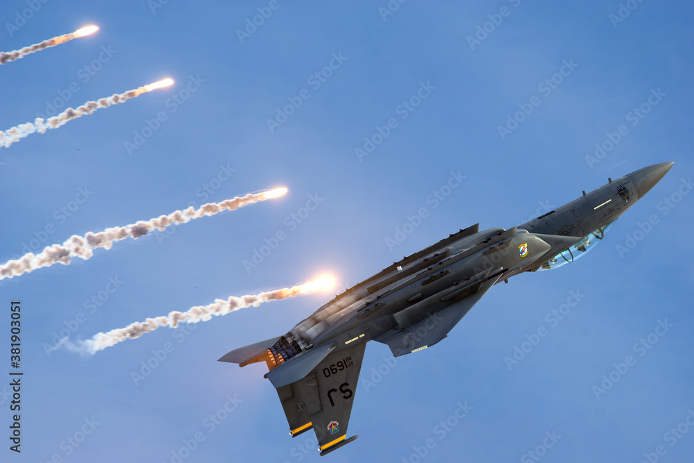 Boeing F-15E Strike Eagle during a defensive maneuver, discharging ...