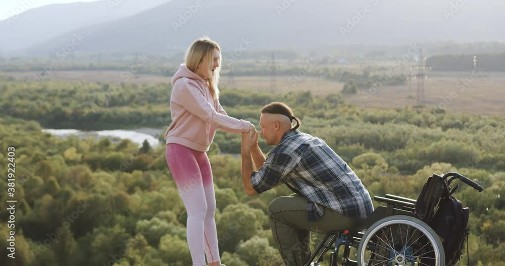 Portrait of good-looking smiling happy couple where disabled man ...