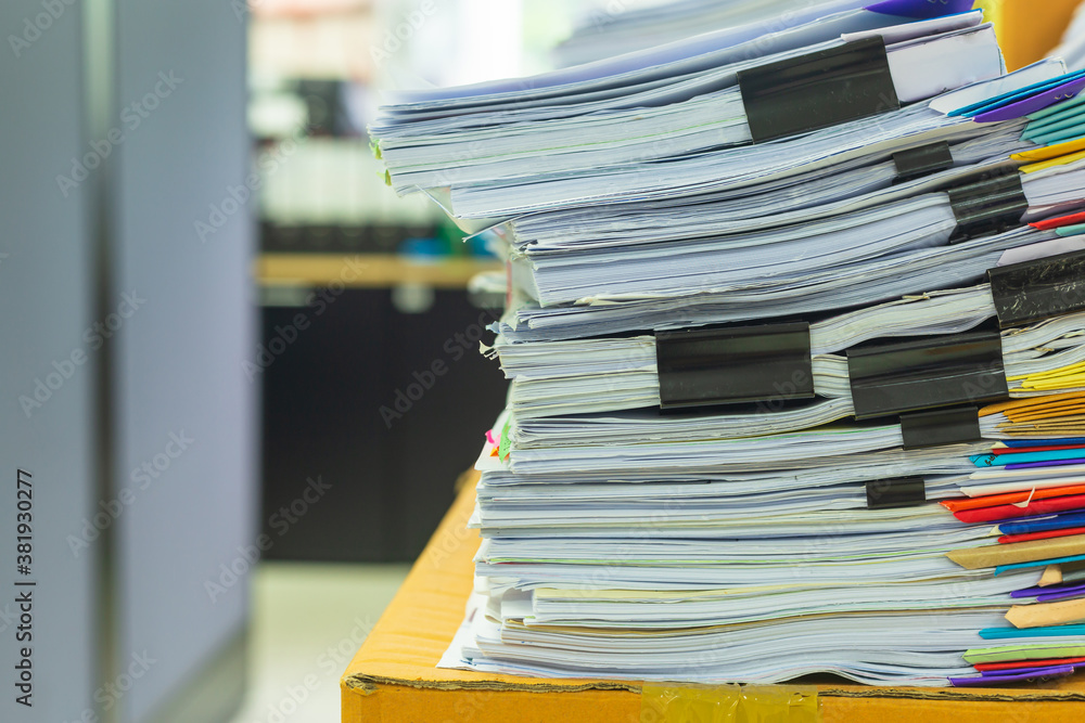 Pile of documents on desk stack up high waiting to be managed Stock ...