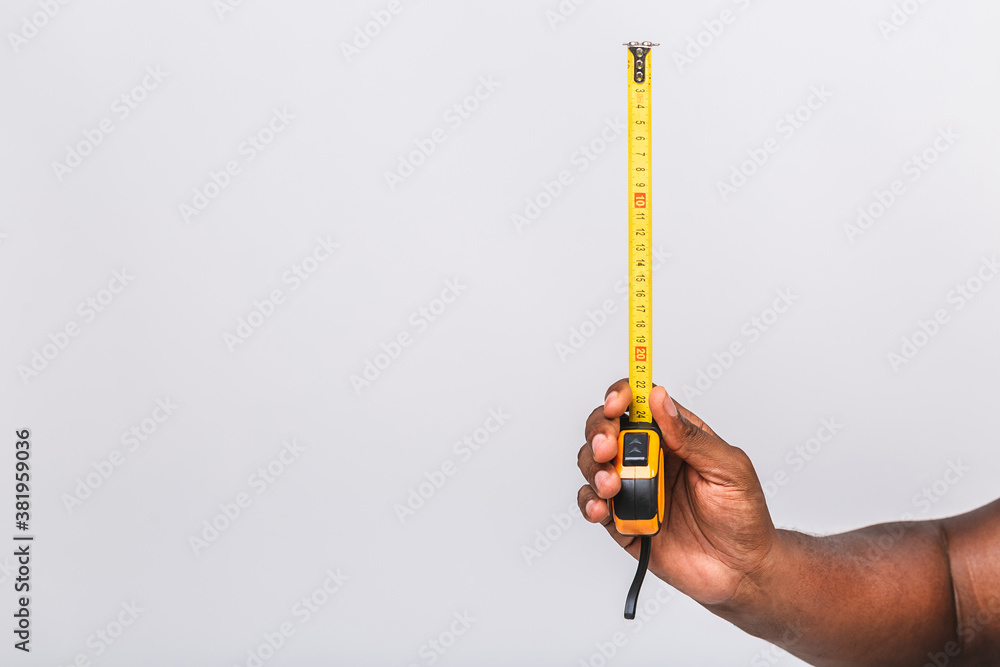 African american black manhands holding measure tape and measuring ...