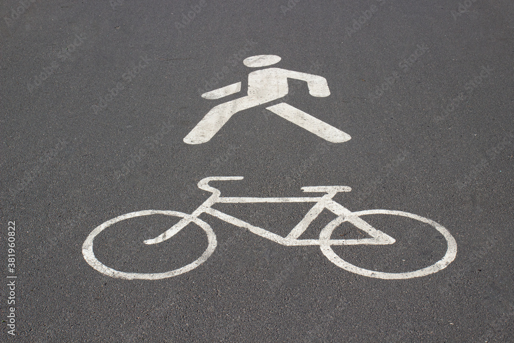 White road markings on pavement. Signs of pedestrian and bike on the ...