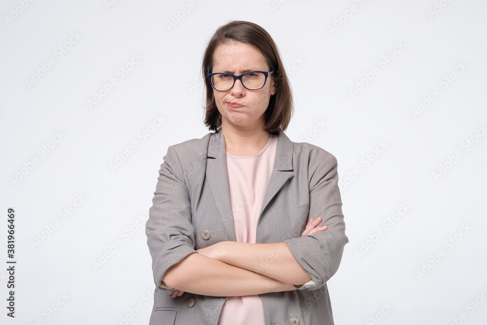 Skeptical mature woman in glasses wearing formal clothes looking ...