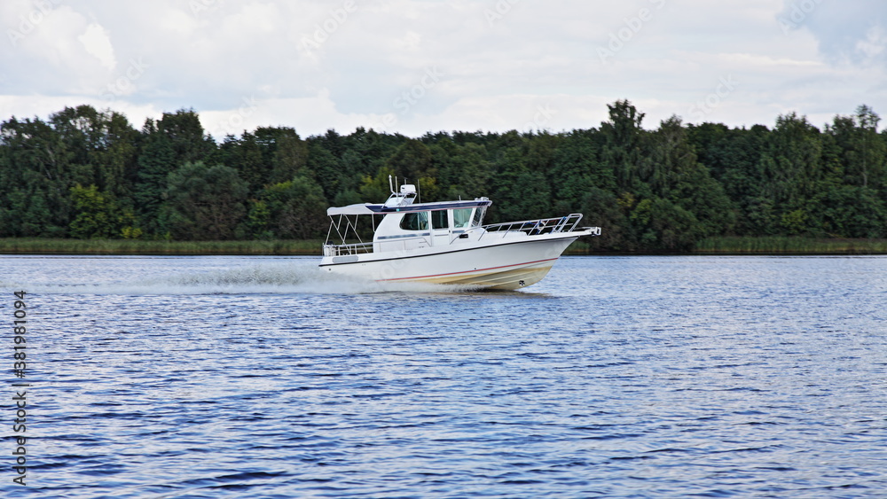 Modern white cabin plastic motor boat with inboard motor fast floating ...