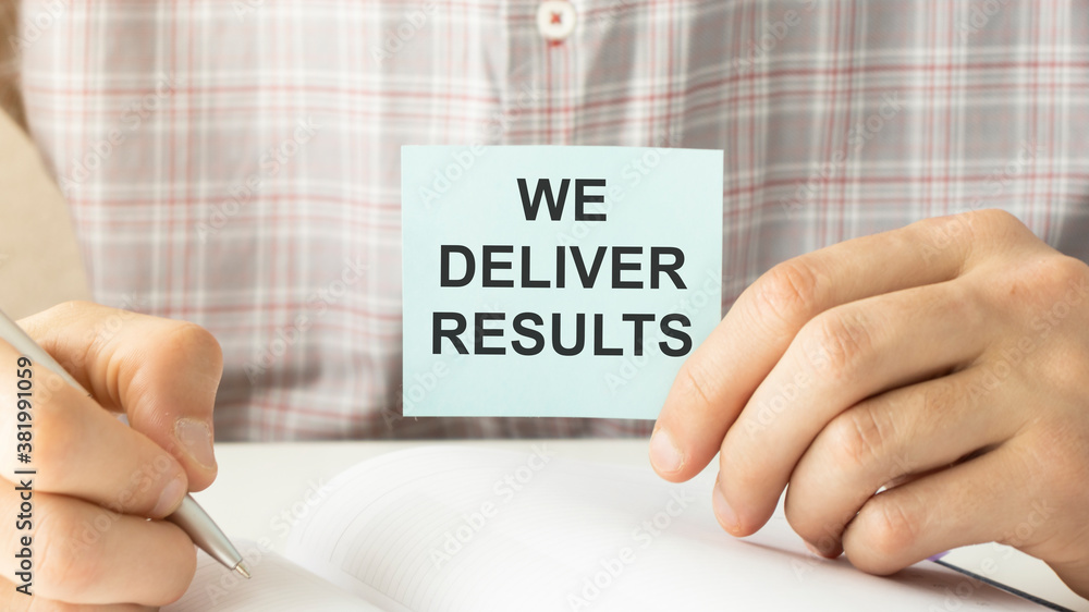 woman holding card with we deliver results text on grey background ...