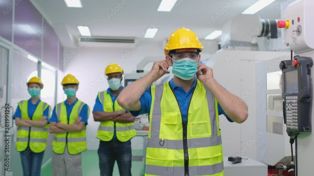 Caucasian factory worker man wear hygiene mask with other co-worker ...