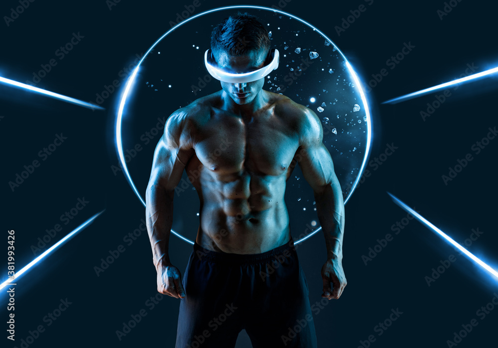 Muscular model sports young man in glasses of virtual reality on dark ...
