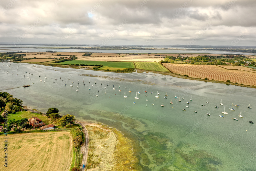 Estuary and yachts surrounded by the beautiful countryside of Southern ...