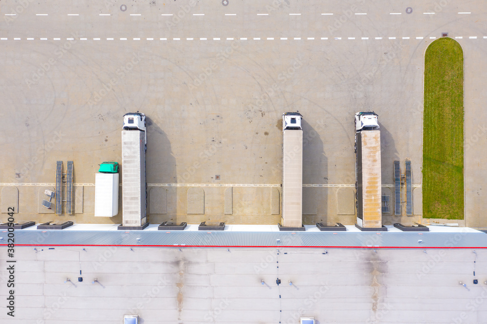 Aerial view of storage and freight terminal with trucks and containers ...