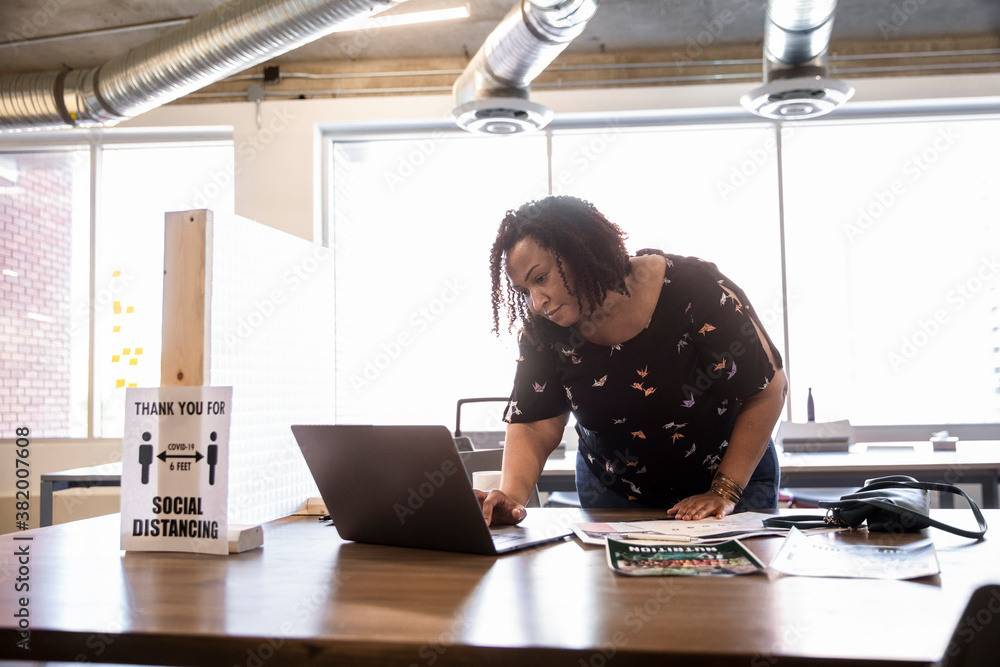Designer planning magazine layout with laptop in coworking space Stock ...