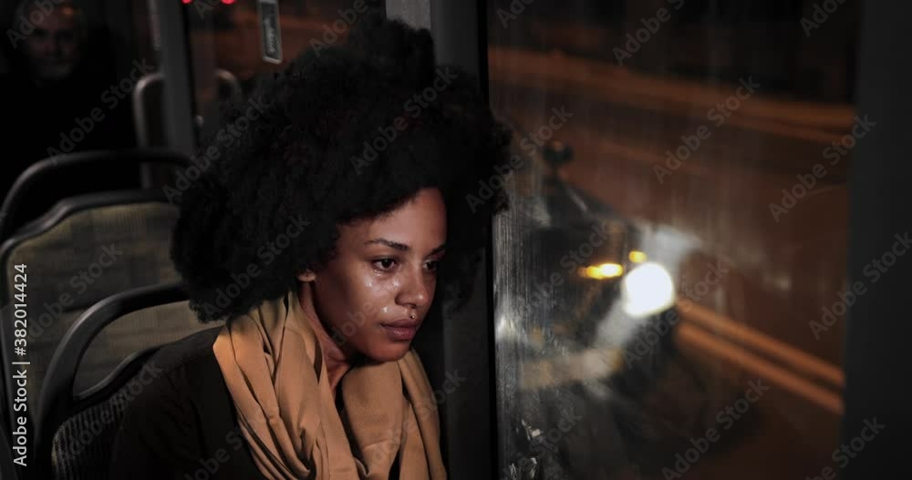 Sad african-american woman sitting on public bus crying wiping tears ...