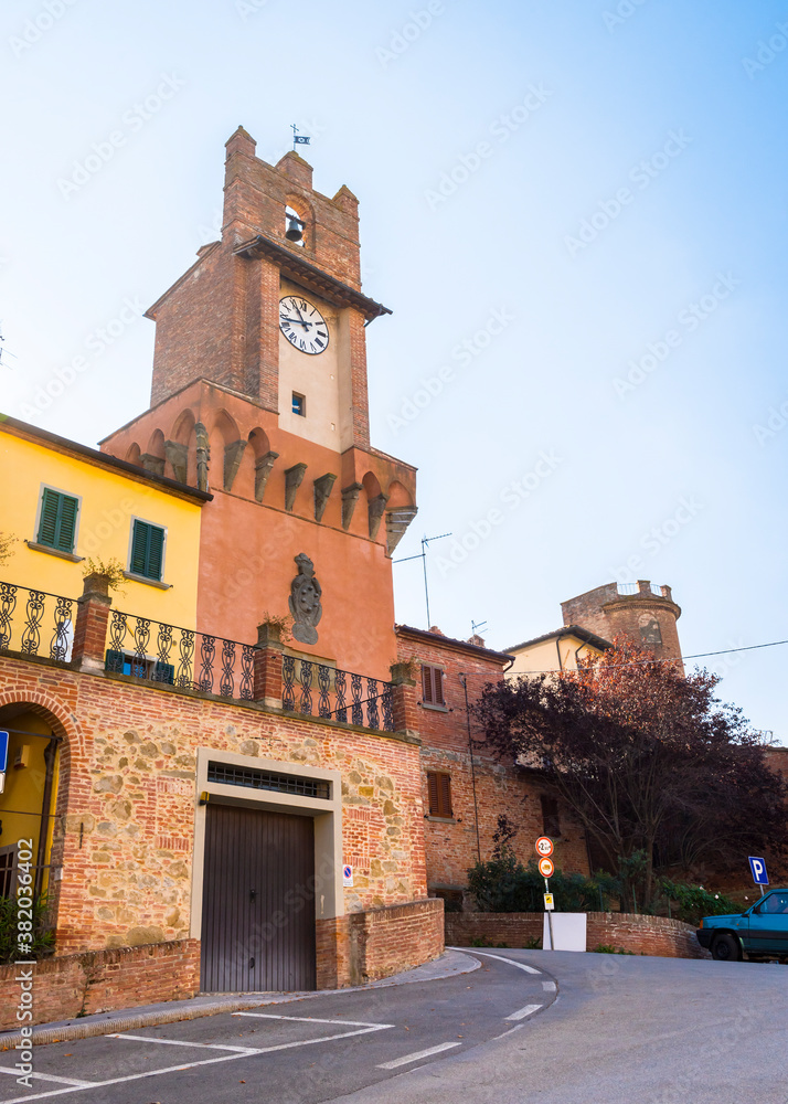 Medieval bell tower with clocks in the town of Marciano in Tuscany ...