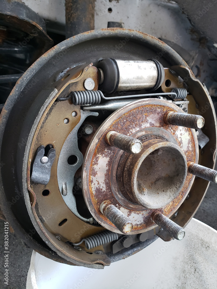 The rear drum brake components of a small passenger vehicle. Springs ...