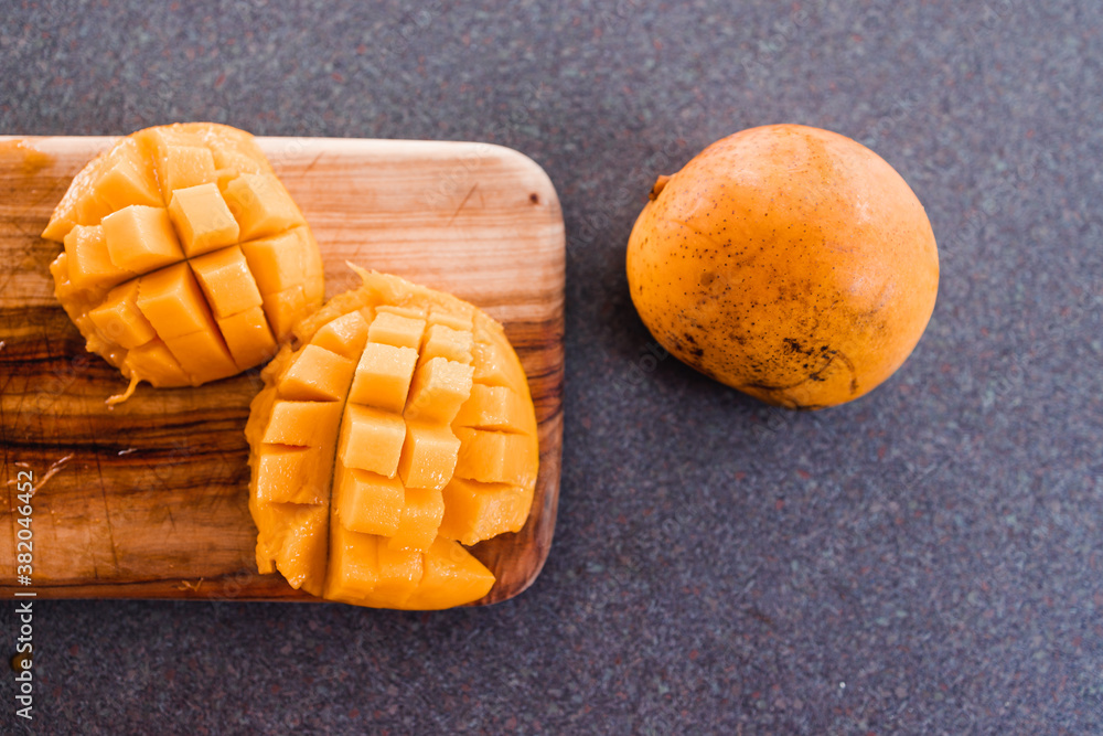 simple food ingredients, sliced mango on cutting board next to another ...
