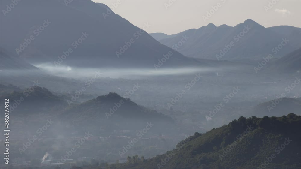 Time lapse of mist lying in the folds of hills.Condensation and ...