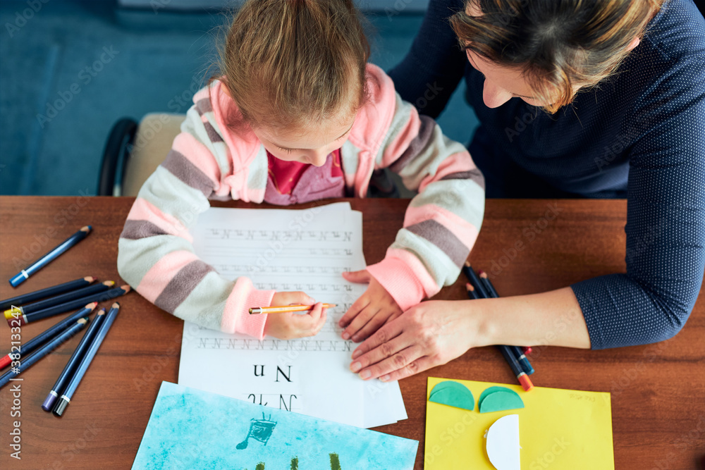 Little girl preschooler learning to write letters with help of her ...