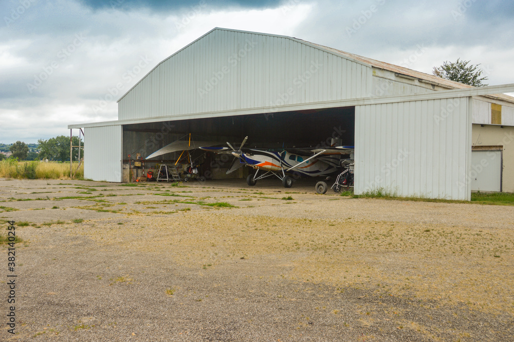hangar with an airplane at a small airfield Stock Photo | Adobe Stock