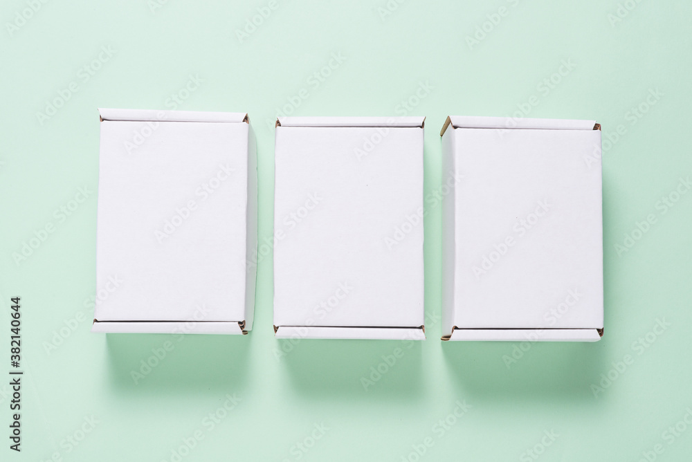 Set of white cardboard, carton flat boxes on mint green background ...